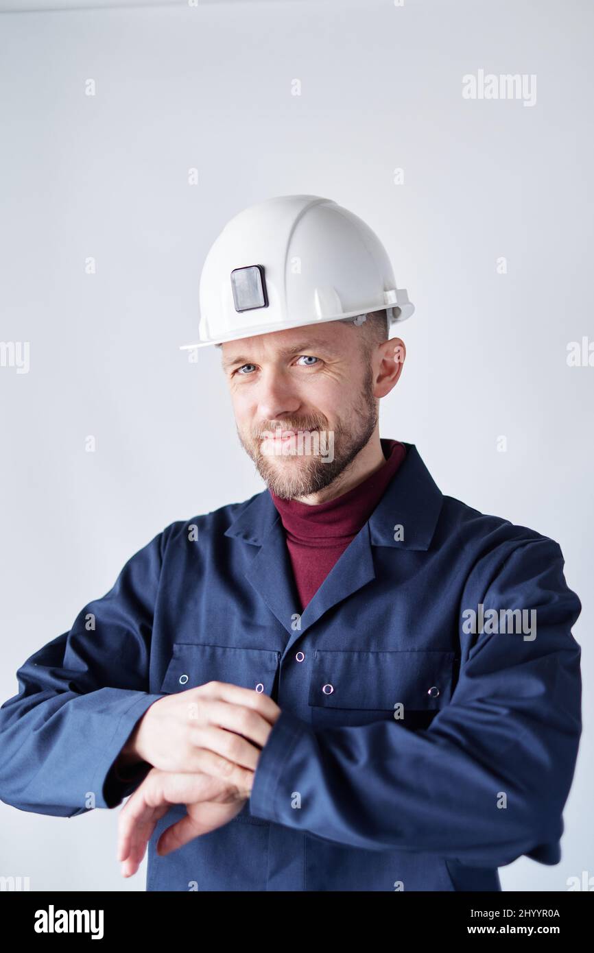 Construction industry concept. Attractive bearded caucasian engineer ... Construction industry concept. Attractive bearded caucasian engineer ...