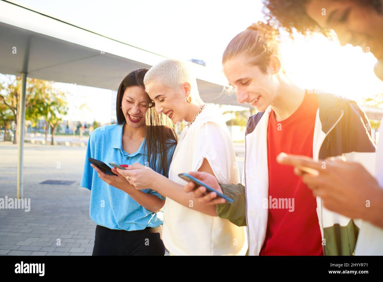 Group of young teenager friends chilling out together using smartphone ...