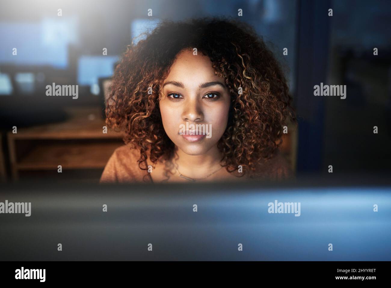 Getting it right, no matter the hour. Shot of a young woman working ...