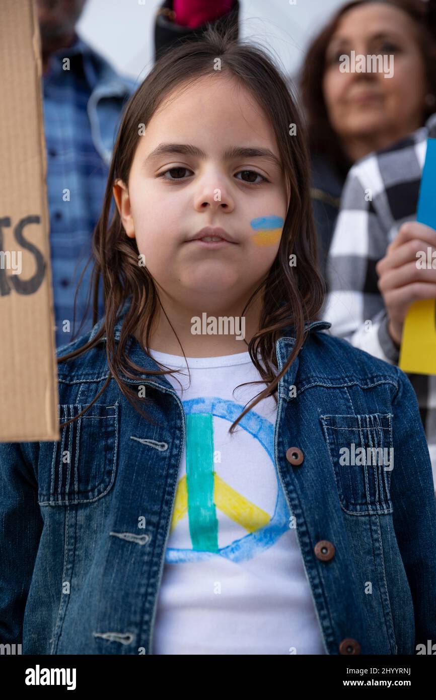 Portrait of little pacifist child during a protest against the invasion ...
