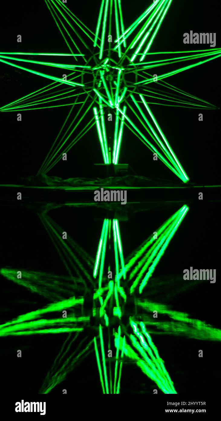 Of a lit up star on a lake during a Lightshow in Kasteeltuinen Arcen ...