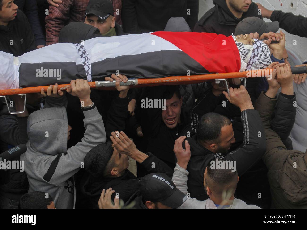 (EDITORS NOTE: Image depicts death) Mourners carry the body of 16-year ...