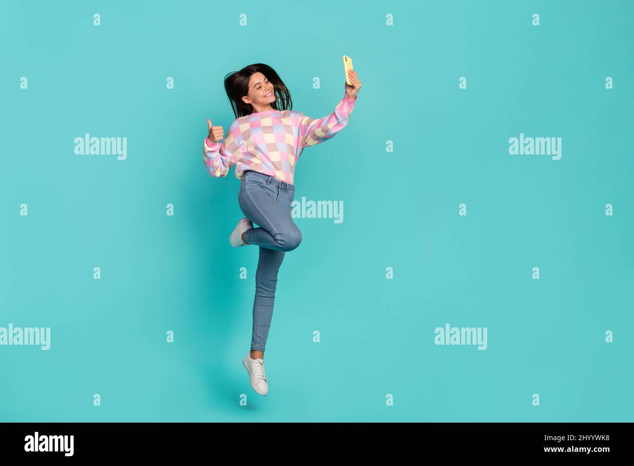 Full length body size view of pretty trendy girl jumping making selfie ...