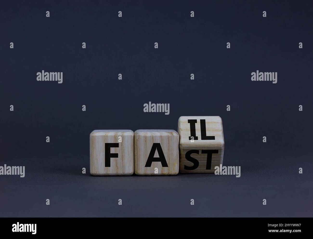 Fail fast symbol. Turned a wooden cube with concept words Fail fast on ...
