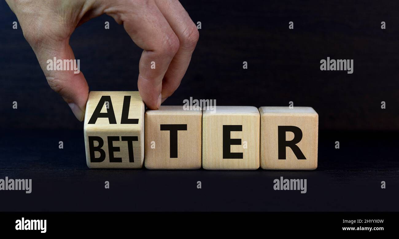 Alter or better symbol. Businessman turns wooden cubes and changes the ...