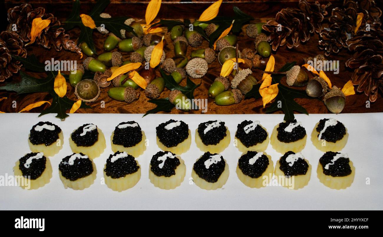 Caviar on potato with sour cream cocktail hors d'oeuvre on tray ...