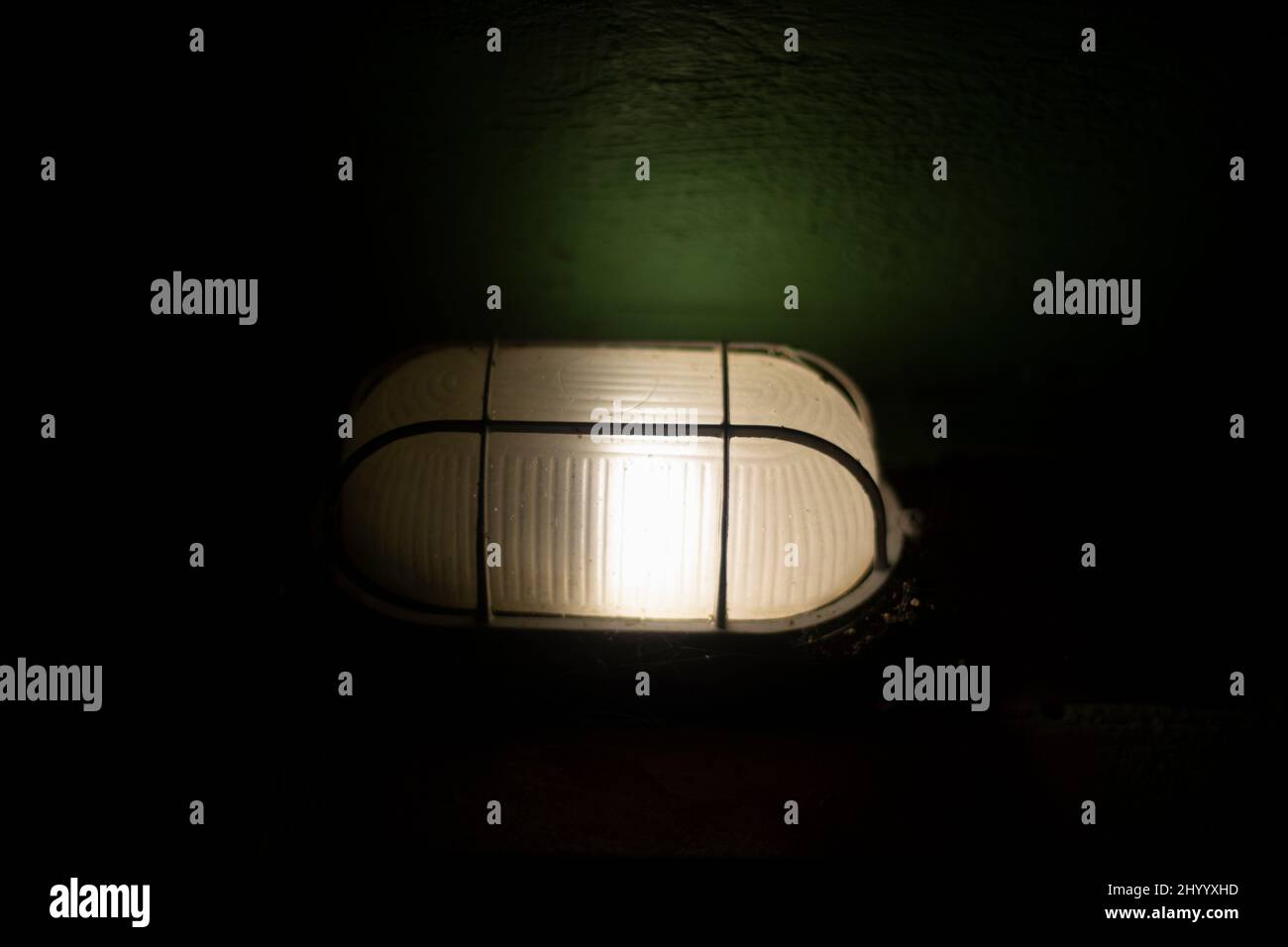 Lamp in entrance. Duty light. Bad equipment. Twilight. Darkness due to ...