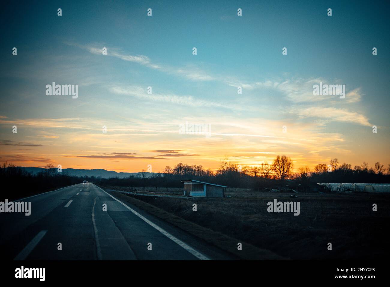 Countryside road during sunset Stock Photo - Alamy