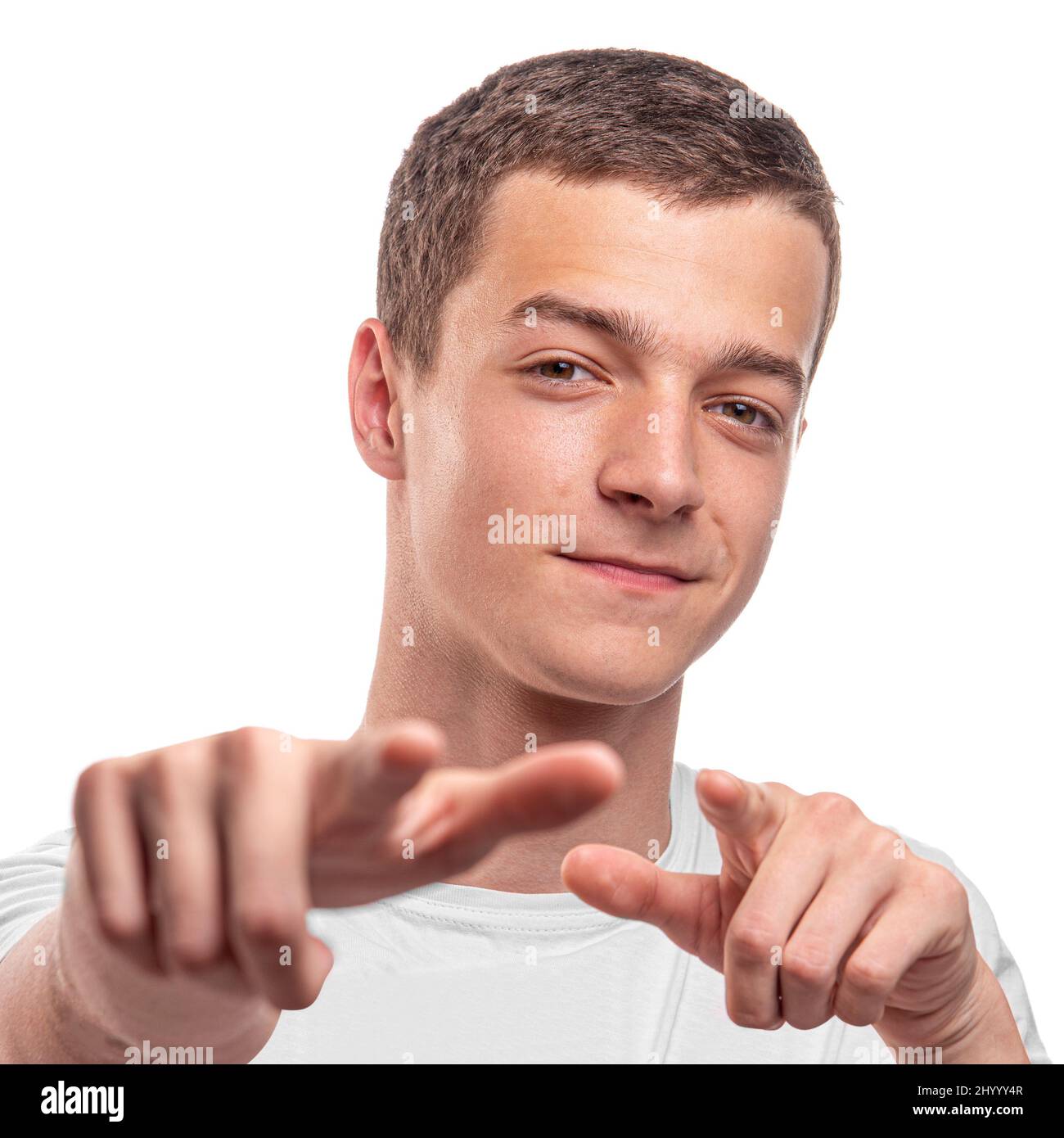 The young man points forward with his fingers. On a white background ...