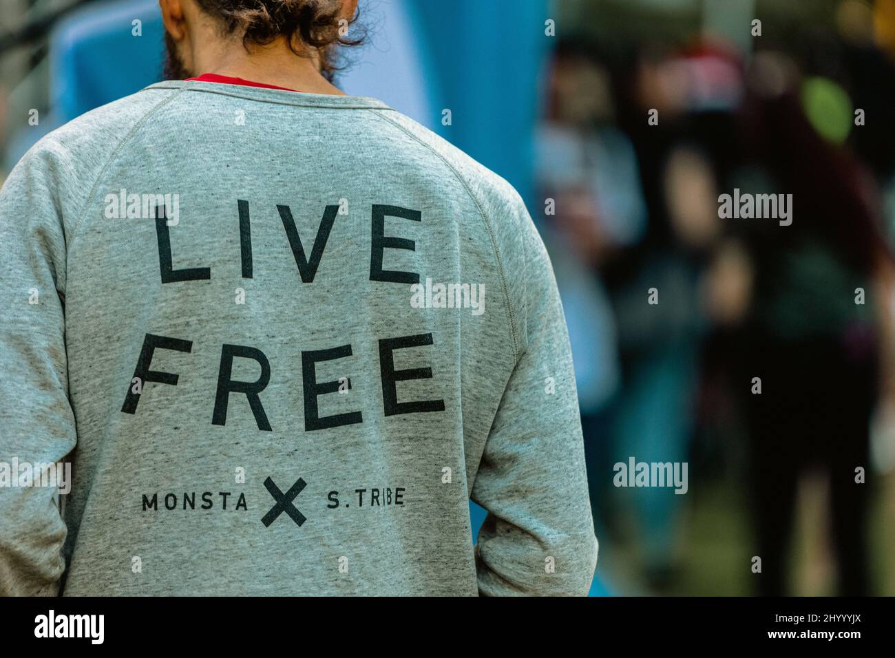 Back view of a male with a "LIVE FREE" shirt on the freedom day protest ...