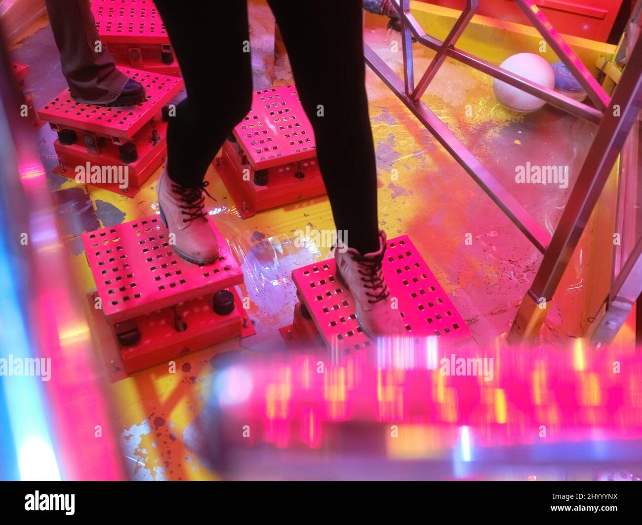 Legs of a woman playing in a fair attraction Stock Photo - Alamy