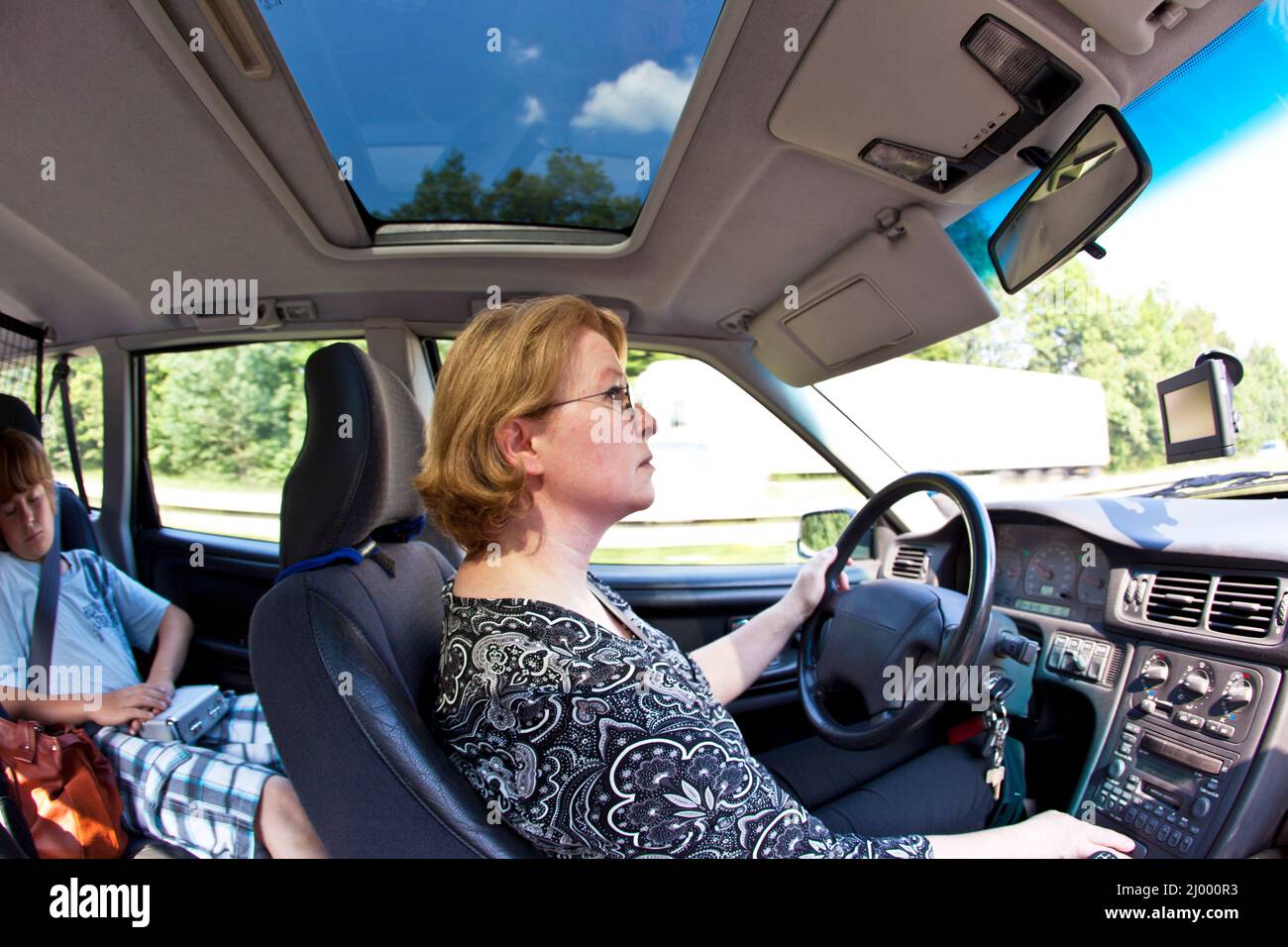 woman is driving car on a highway Stock Photo - Alamy