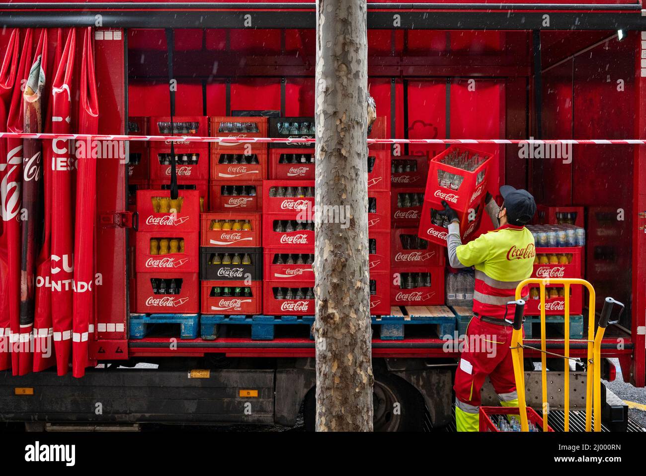 Delivery truck workers offload American soft drink brand Coca-Cola ...