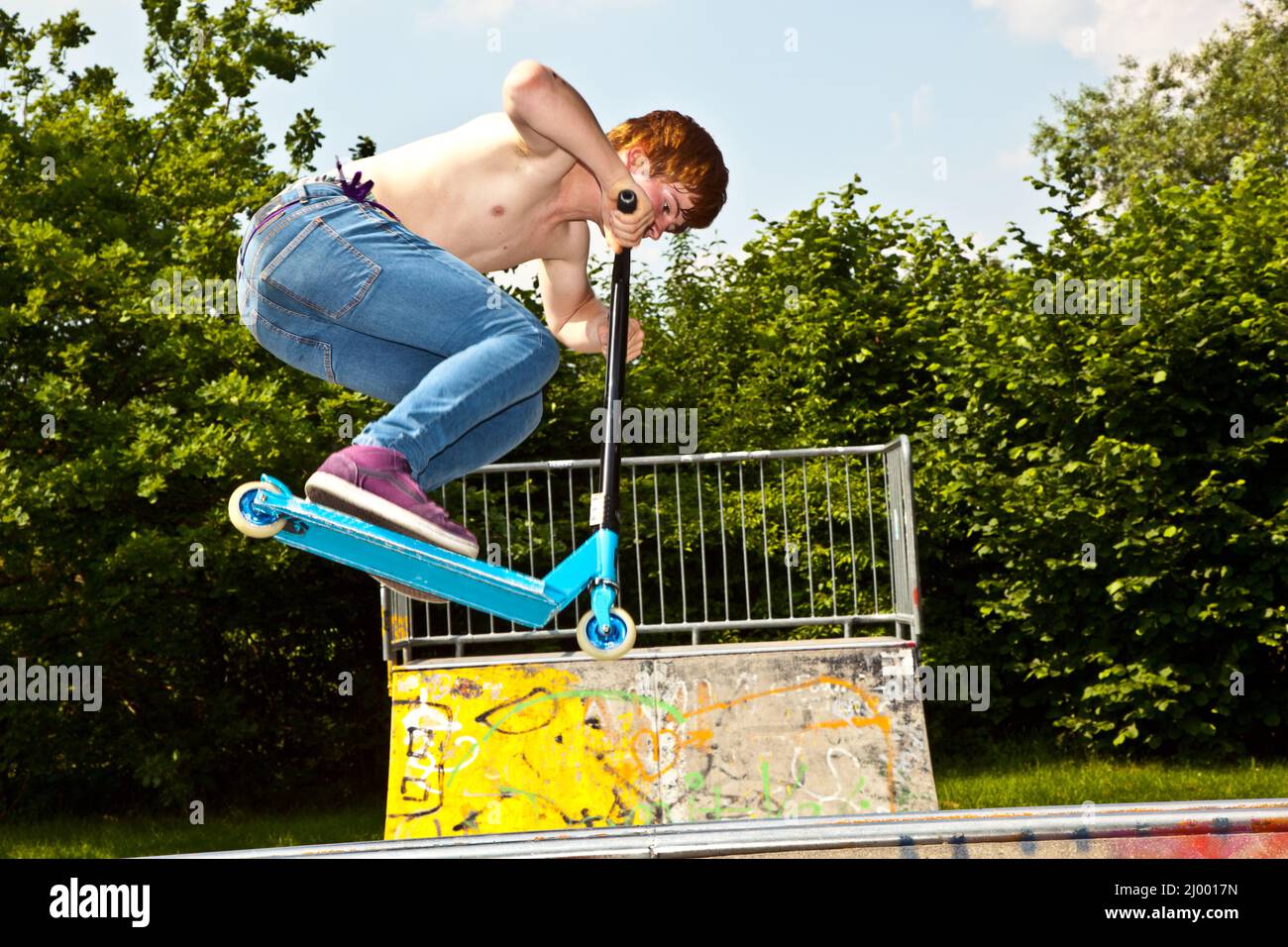 young boy going airborne with his scooter Stock Photo - Alamy