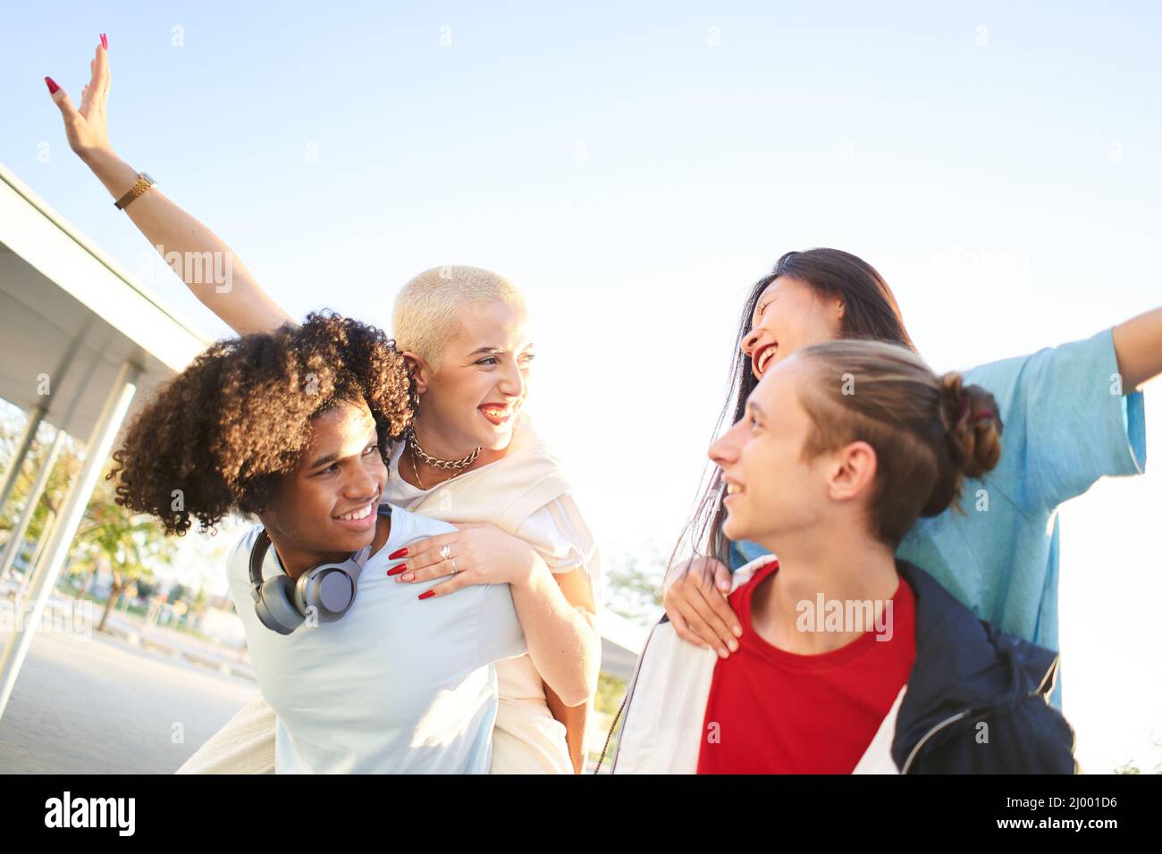 Group of students on city street smiling. Young people having fun on ...