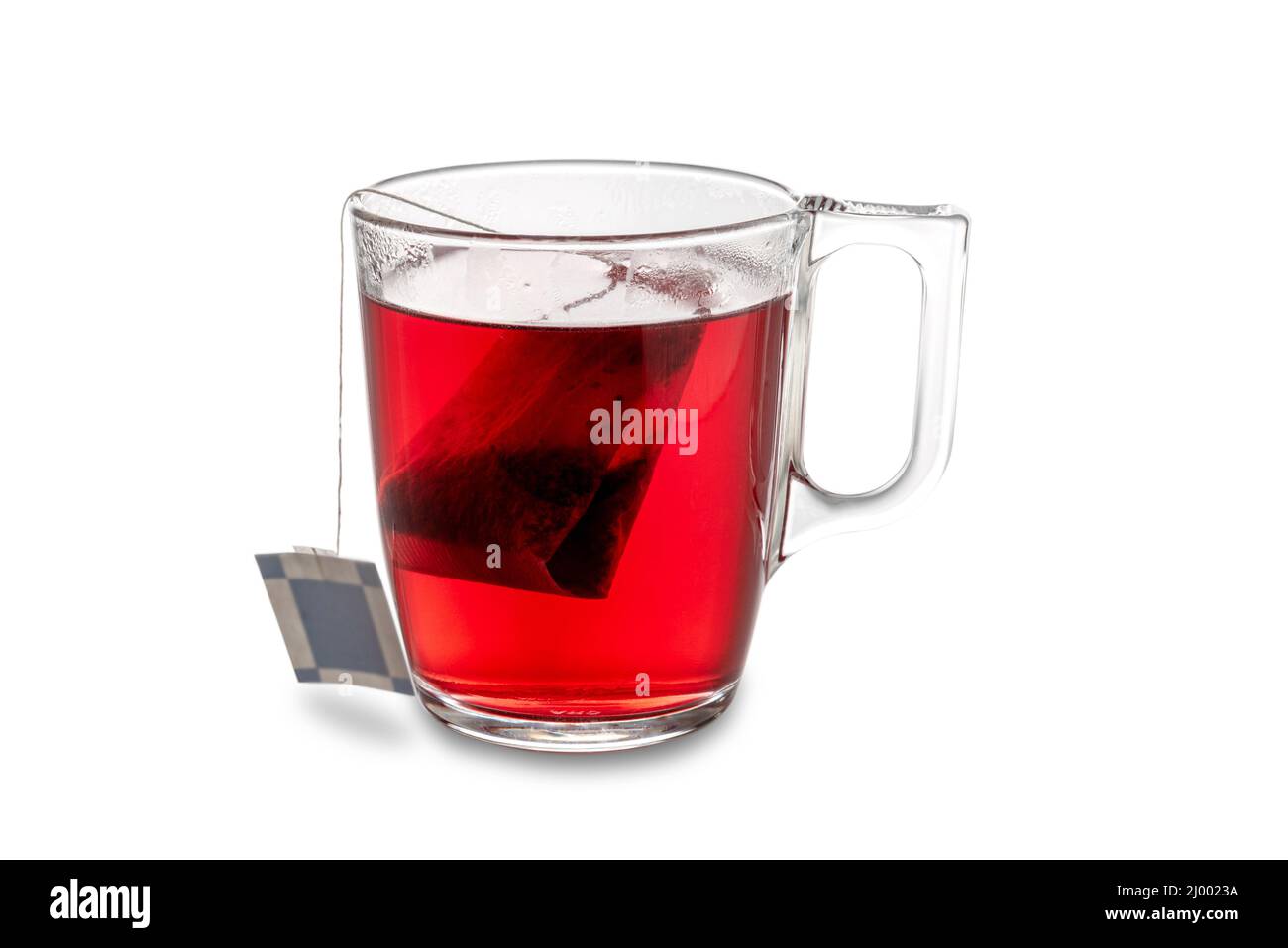 Red fruit herbal tea, herbal tea infusion bag in transparent glass cup ...