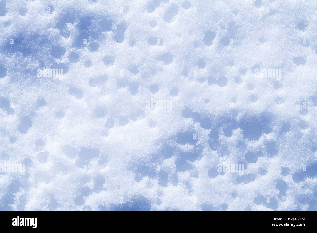 Melting snowdrift surface on a sunny day, top view, natural background ...