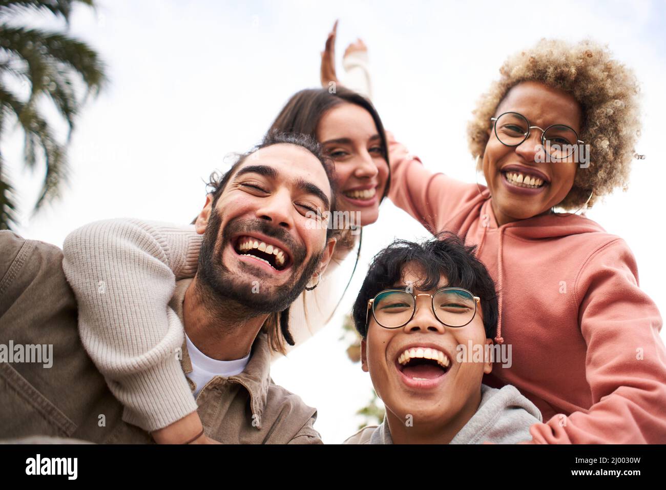 Group of young people looking at the camera outdoors. Happy smiling ...