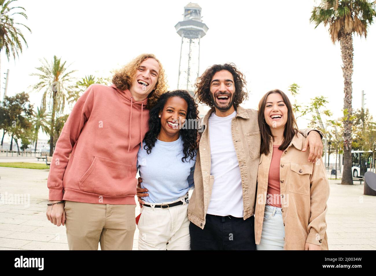 Four friends looking at the camera and smiling. Two couples having fun ...