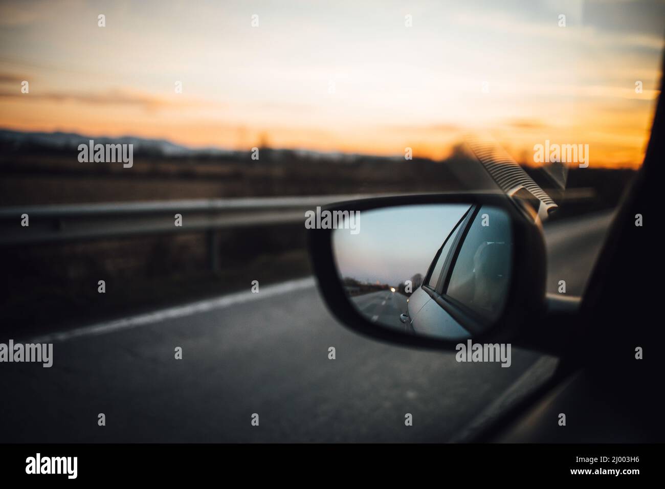 Car mirror with sunset sky reflection Stock Photo - Alamy