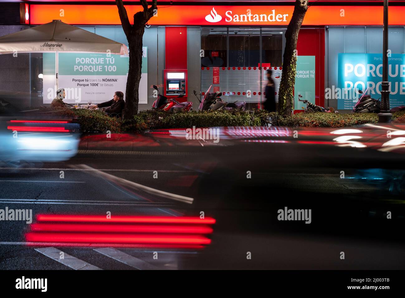 Cars drive past the Spanish multinational commercial bank and financial ...
