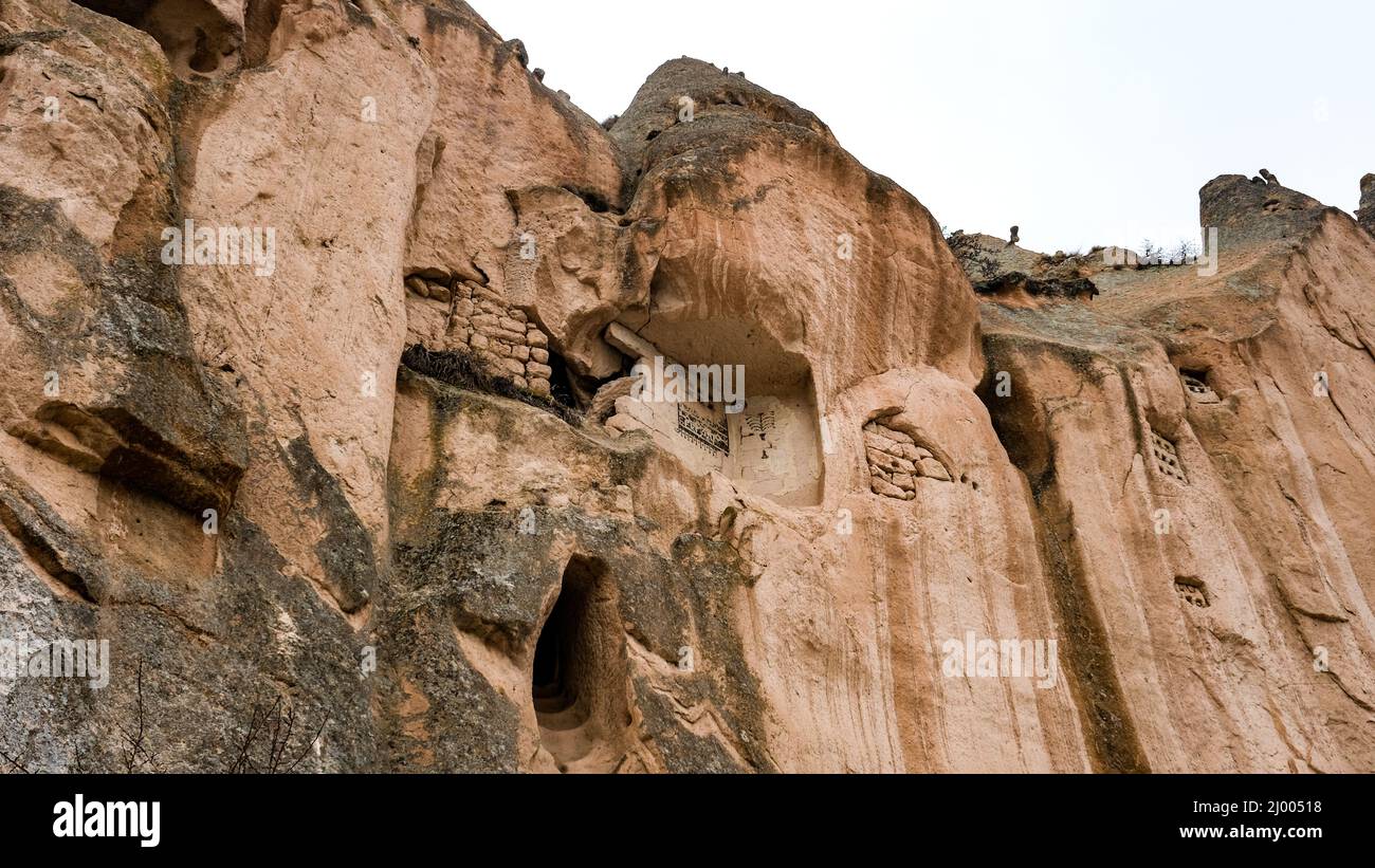 Low angle shot of stone formations and fairy chimneys in Cappadocia ...