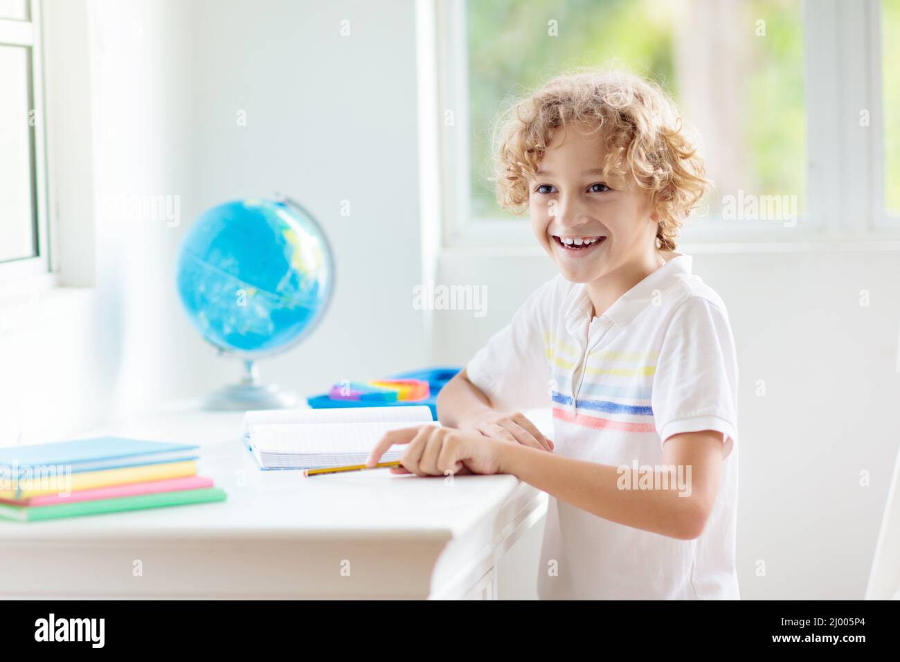 Online remote learning. School kids with computer having video ...