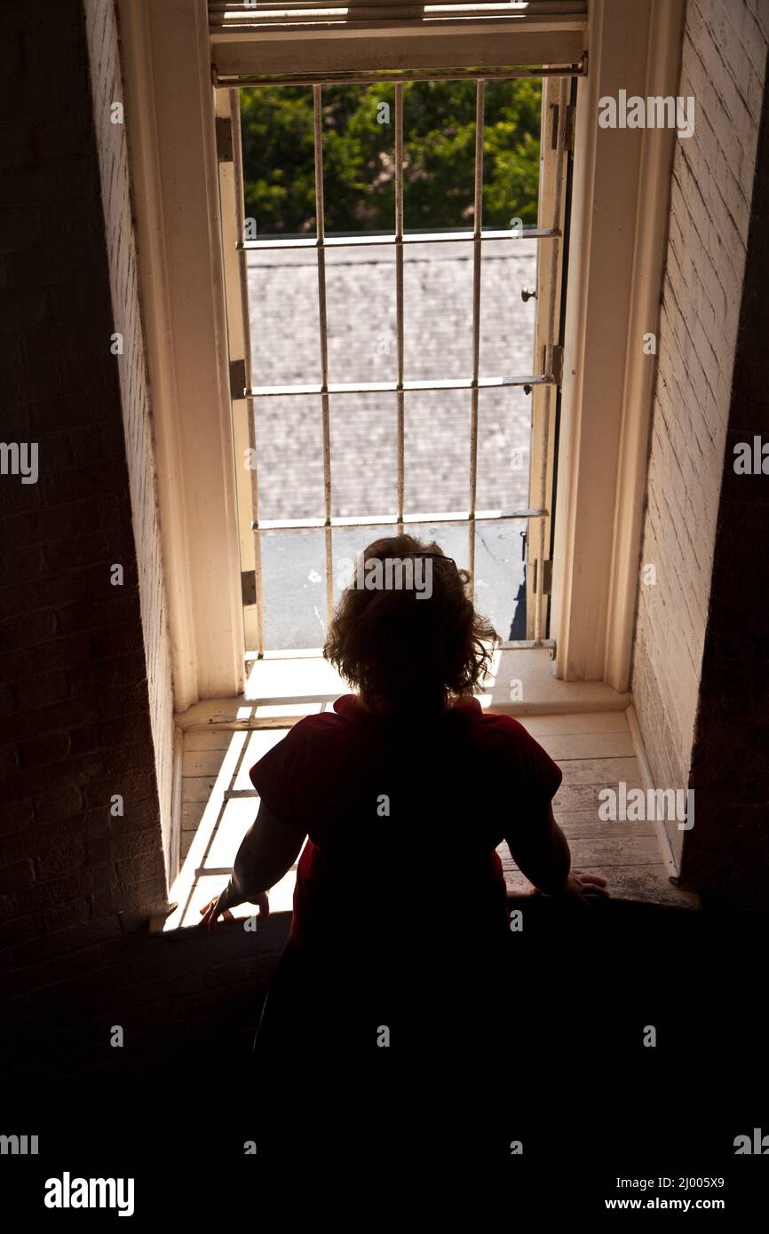woman looking out of a lighthouse Stock Photo - Alamy