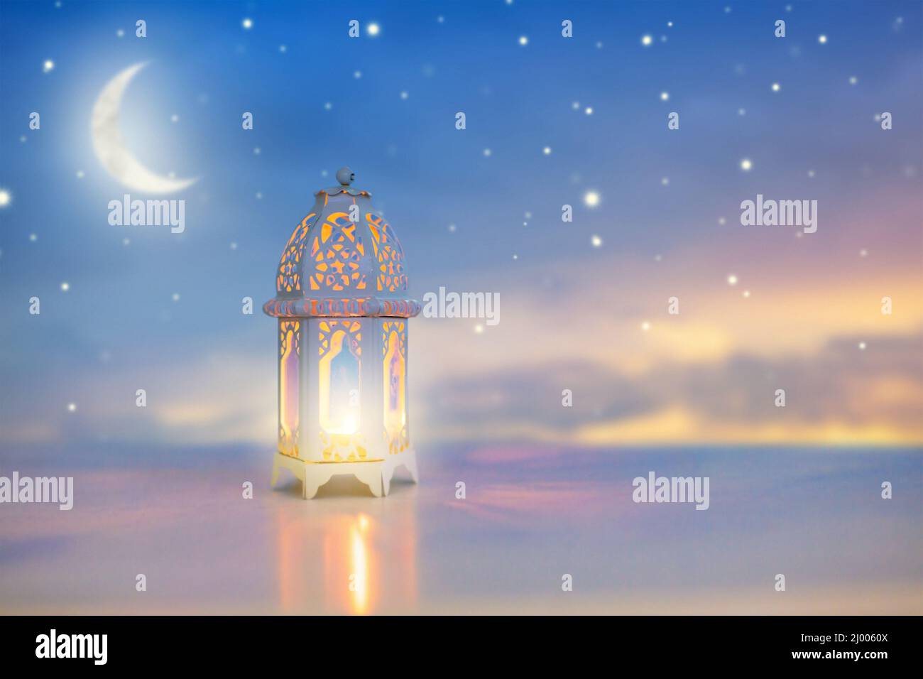 Ramadan Kareem greeting. Islamic lantern on night sky with crescent moon and stars. End of ...