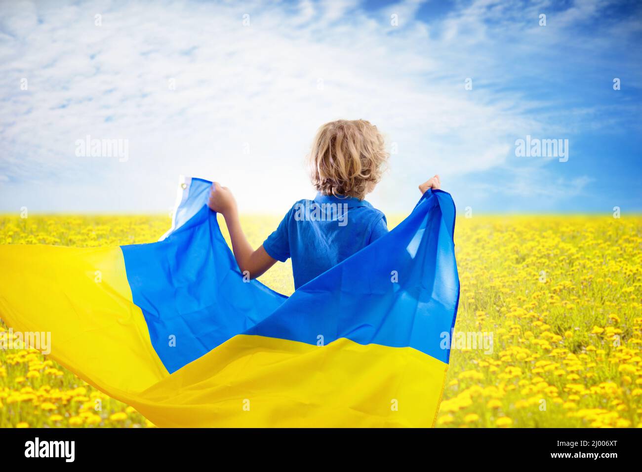 Pray for Ukraine. Child with Ukrainian flag. Little blond boy waving ...