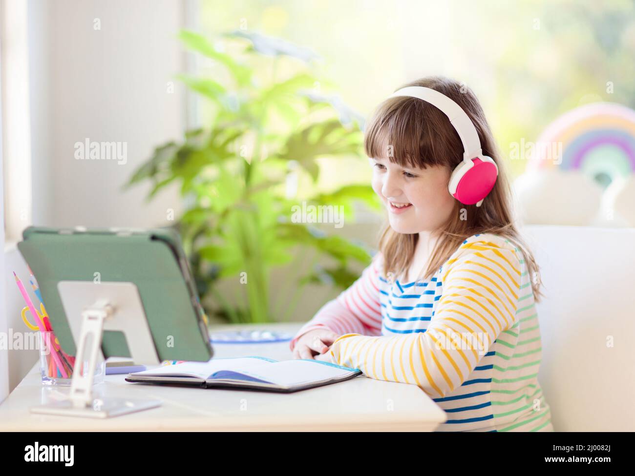Online remote learning. School kids with computer having video ...
