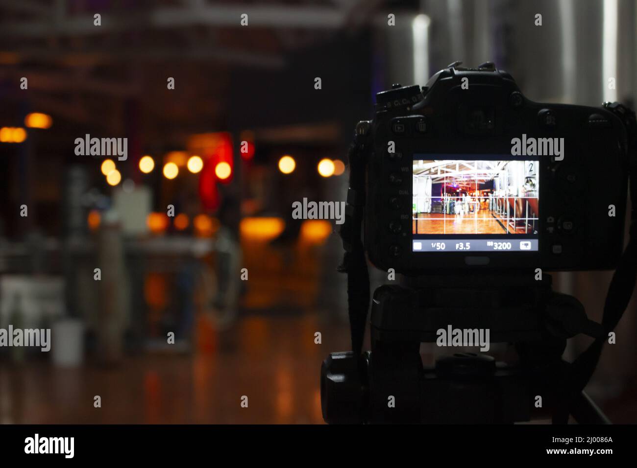 Selective focus of a professional camera recording inside a building ...