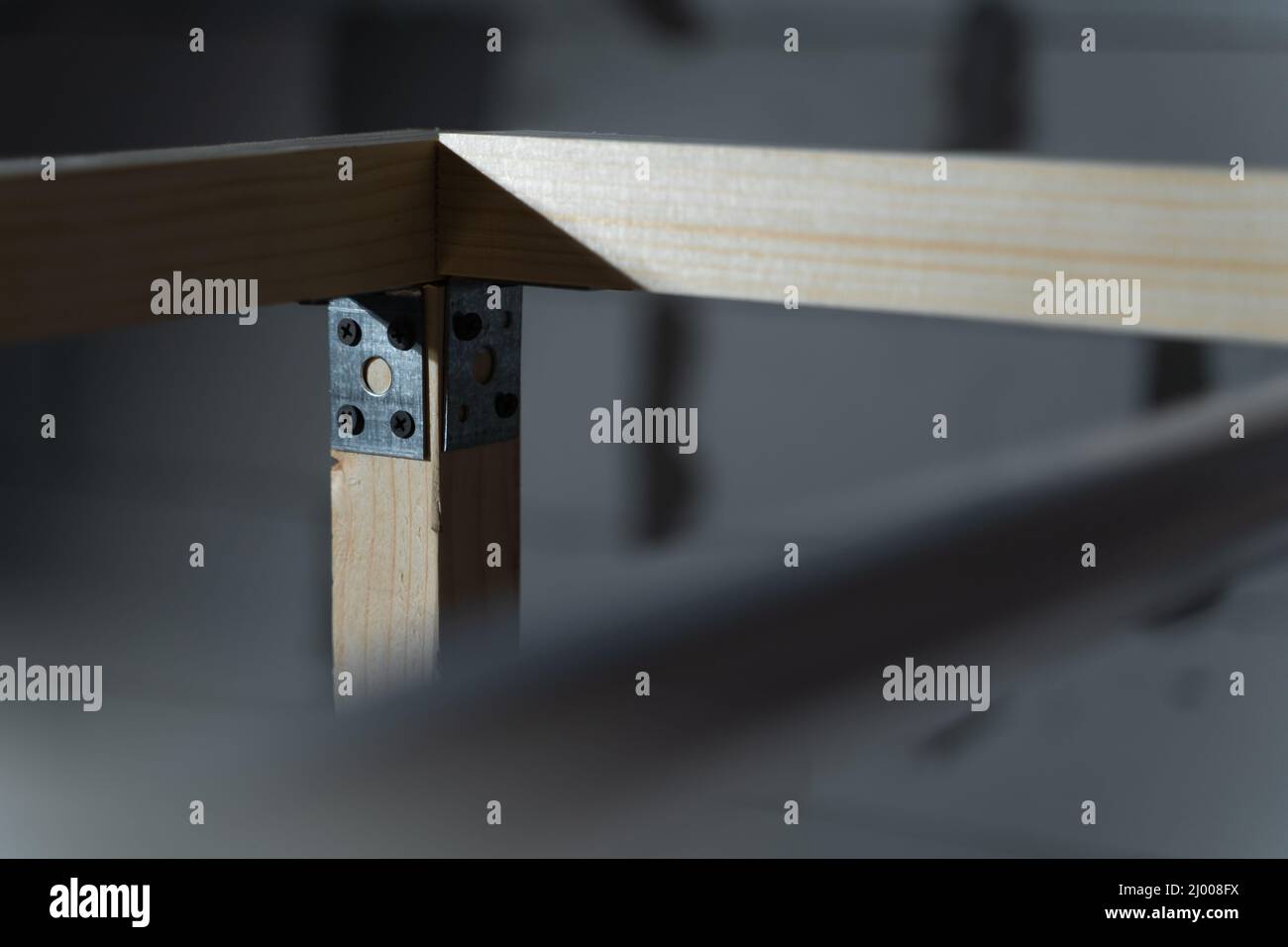 Corner connection of wooden bars with iron corners and black self ...