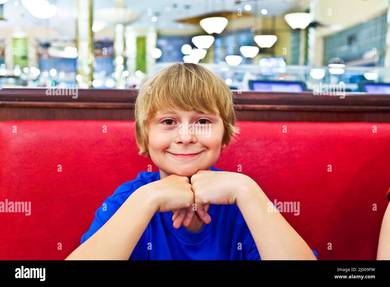 smiling boy in a diners at night Stock Photo - Alamy
