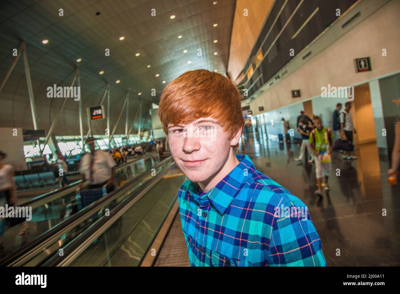young boy on a moving staircase at the airport Stock Photo - Alamy