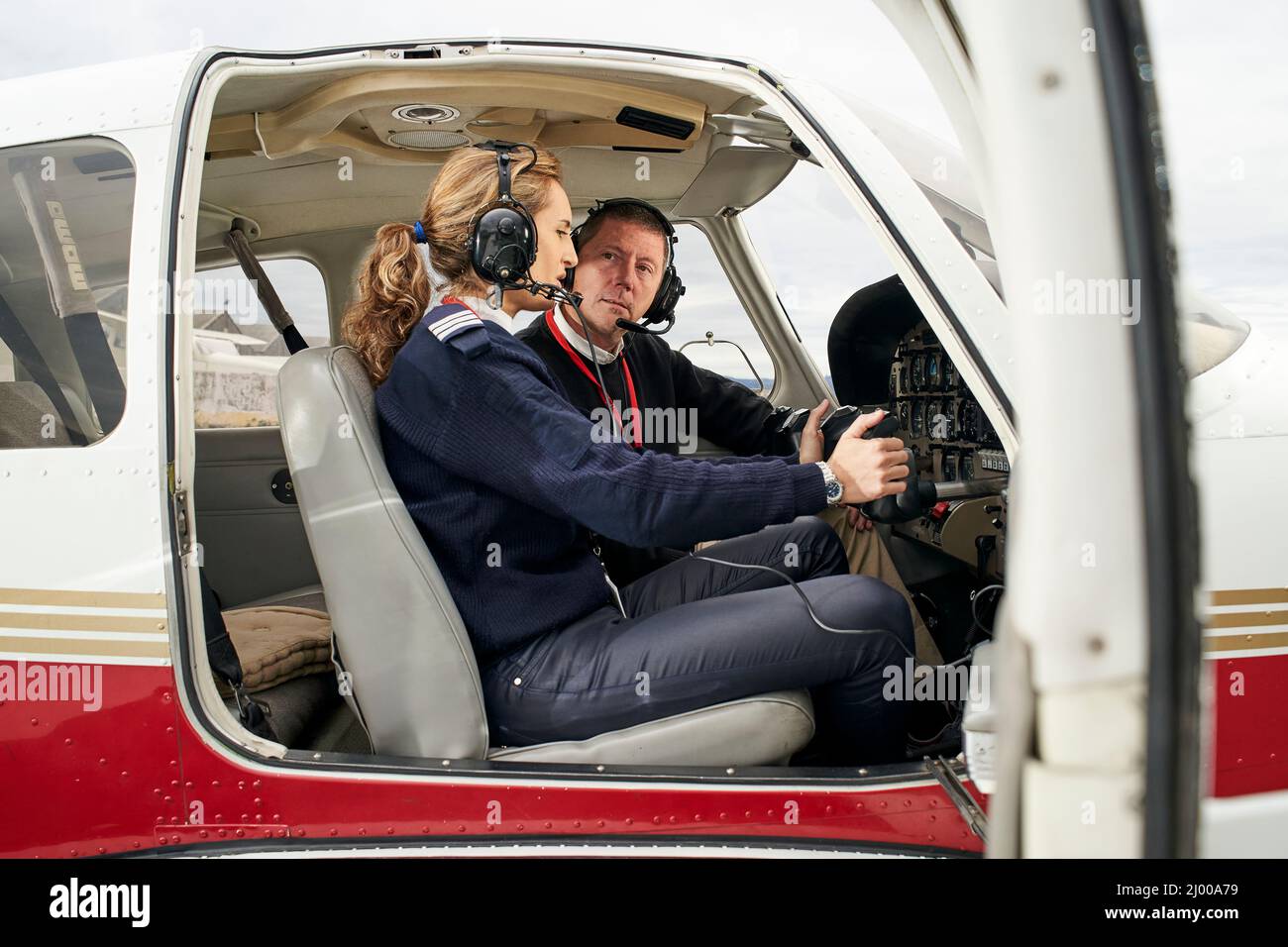 Pilot in training and flight instructor in the cockpit of an airplane ...