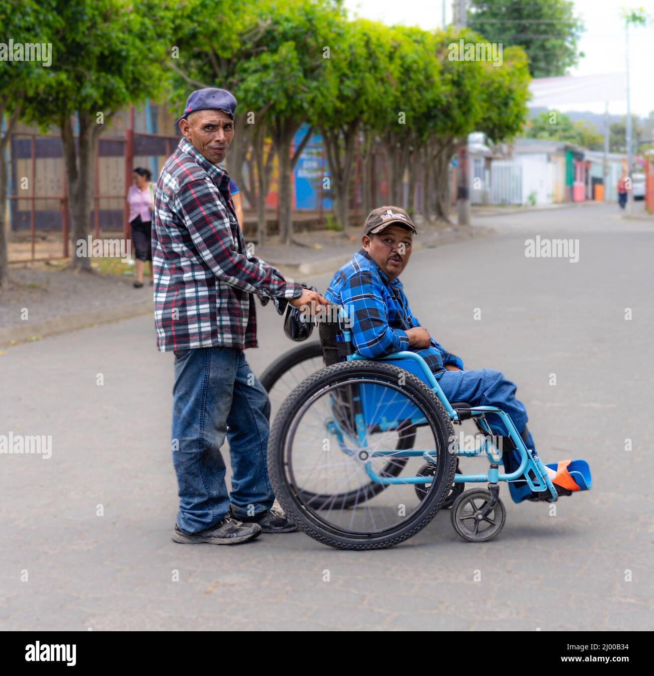 Man pushing another man in a wheel chair in Nicaragua. The man in the ...