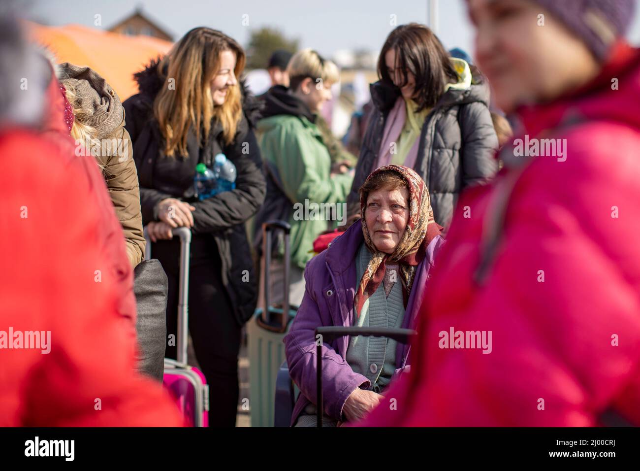 Przemysl, Poland. 15th Mar, 2022. Refugees from Ukraine wait shortly ...