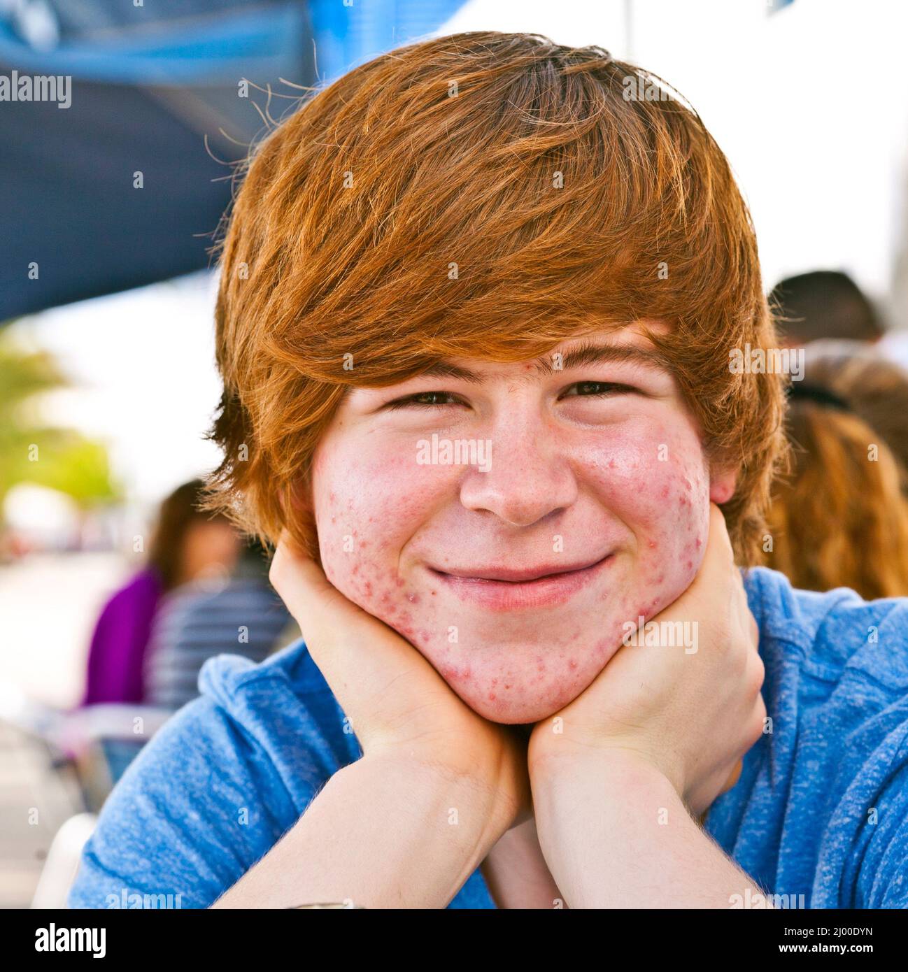 outdoor portrait of relaxed cute young boy looking positive and ...