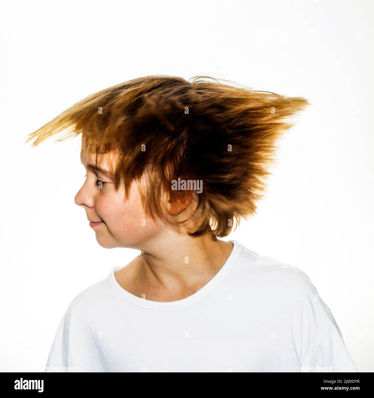 boy has fun turning his head with flying hairs Stock Photo - Alamy