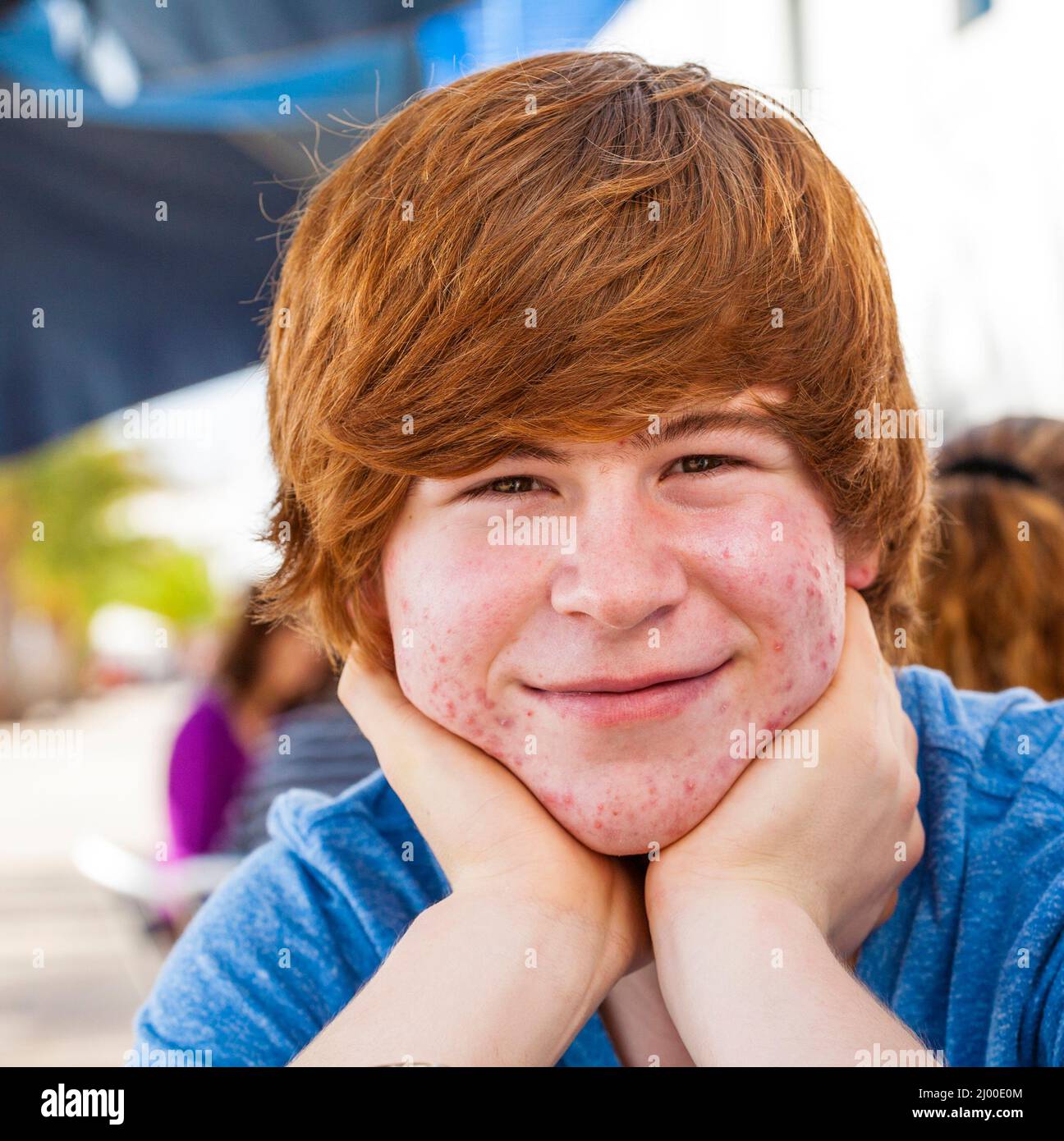 outdoor portrait of relaxed cute young boy looking positive and ...