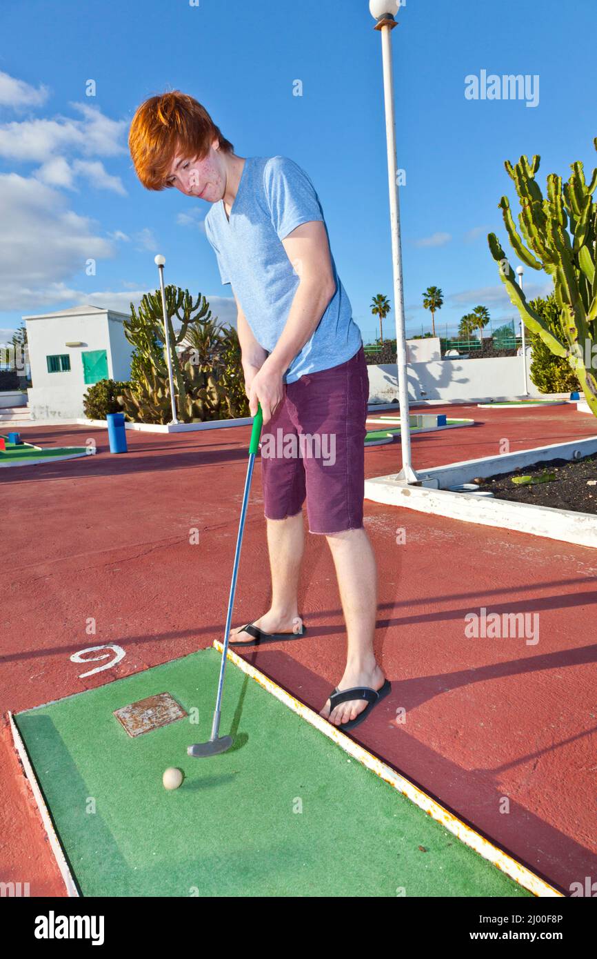 boy playing mini golf in the course Stock Photo - Alamy