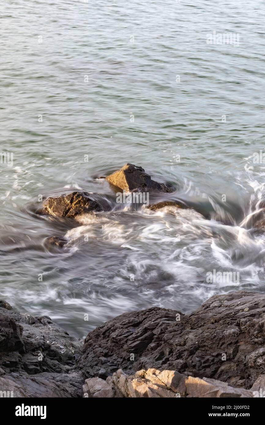 rugged stony surf along coast line Stock Photo - Alamy