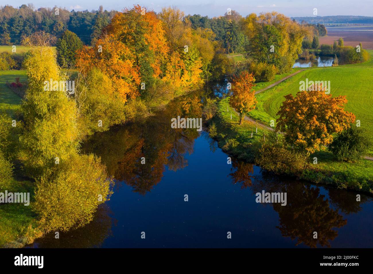 A greenfield and a water path with some trees Stock Photo - Alamy