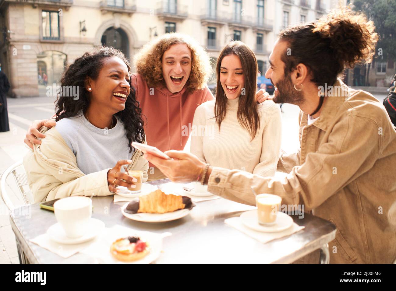 People group talking at coffee bar terrace watching screen phone ...