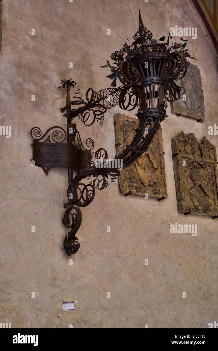 An old beautiful forged lamp on the wall with beautiful details Stock ...