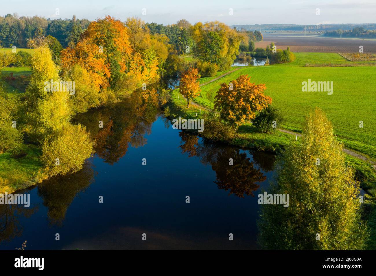 A greenfield and a water path with some trees Stock Photo - Alamy