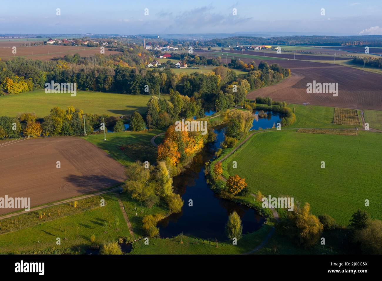 A greenfield and a water path with some trees Stock Photo - Alamy