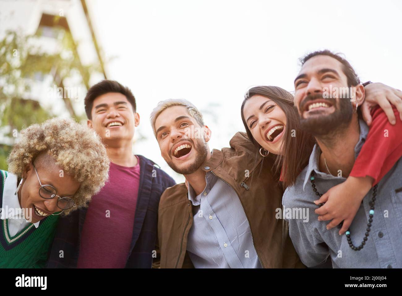 Three couples having fun piggybacking at sundown Stock Photo - Alamy