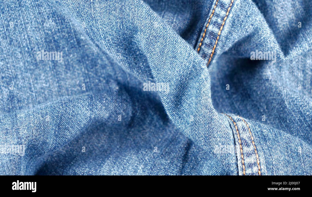 wrinkled jeans fabric, not flat, with hollows and waves, blurred Stock ...